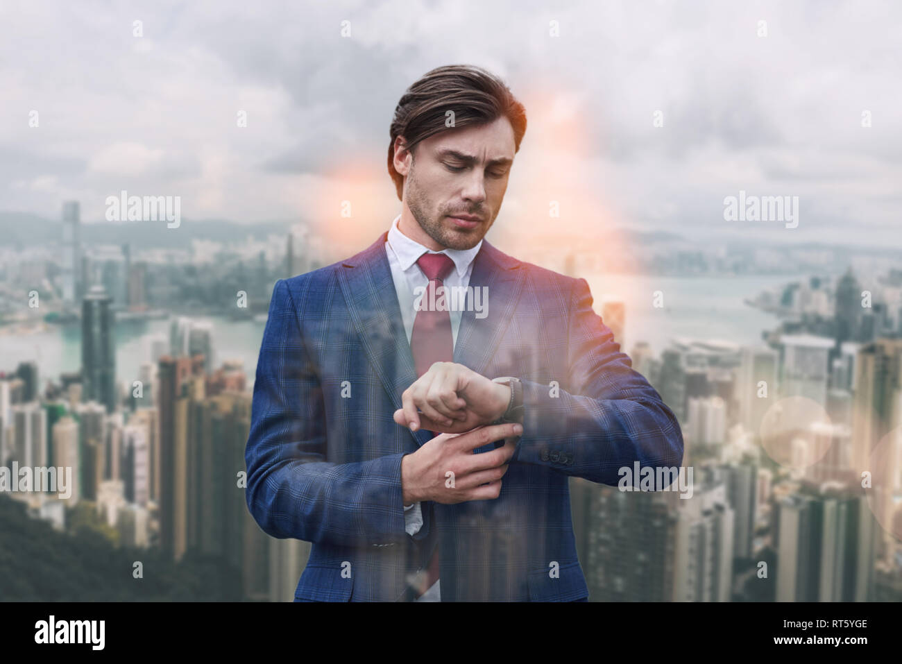 What time is it? Busy and confident businessman in suit looking at his ...