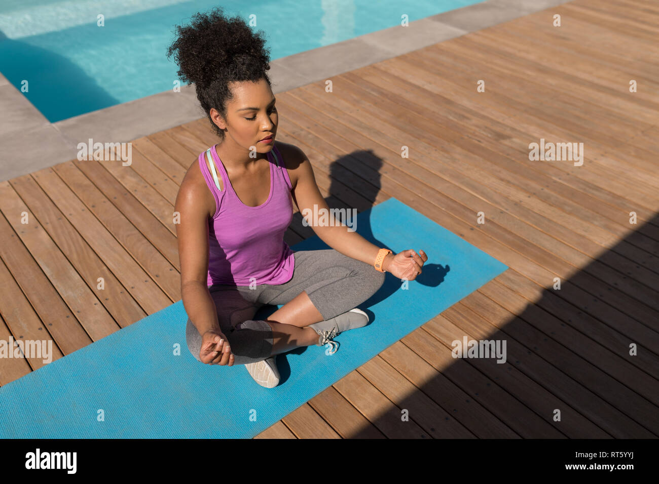 Woman performing yoga in the backyard of home Stock Photo - Alamy