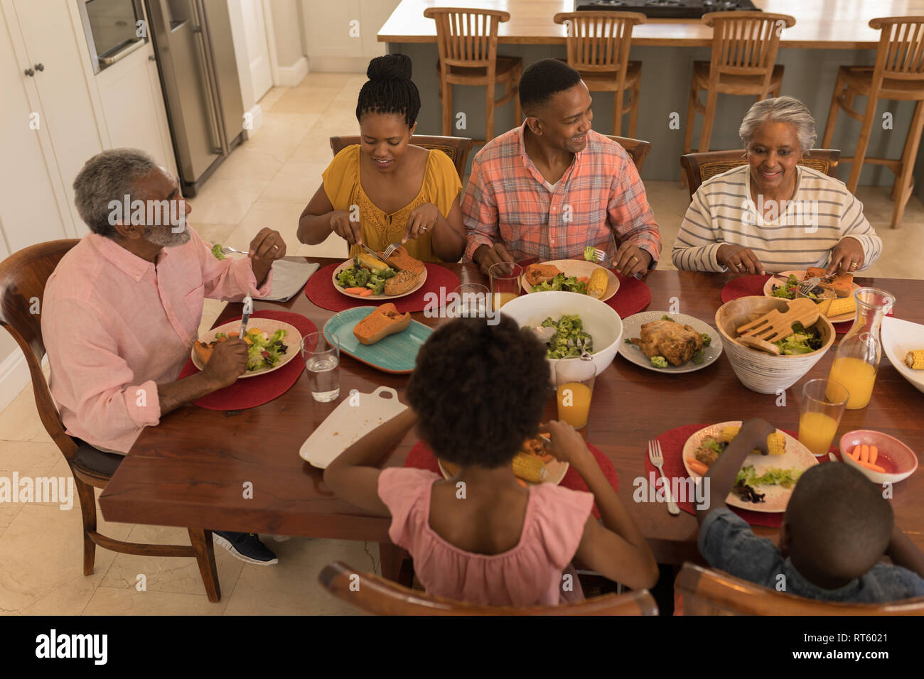 Multi-generation family having meal together on dining table Stock ...