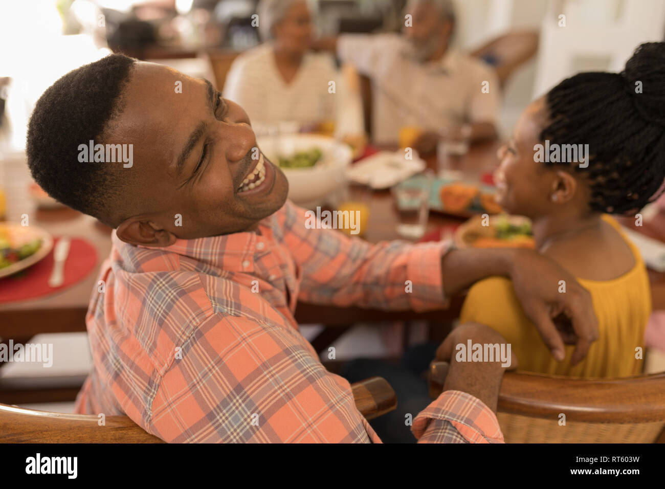 Family having fun on dining table at home Stock Photo - Alamy