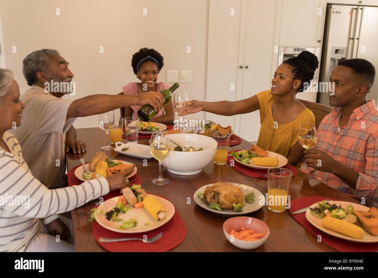 Multi-generation family having meal together on dining table Stock ...