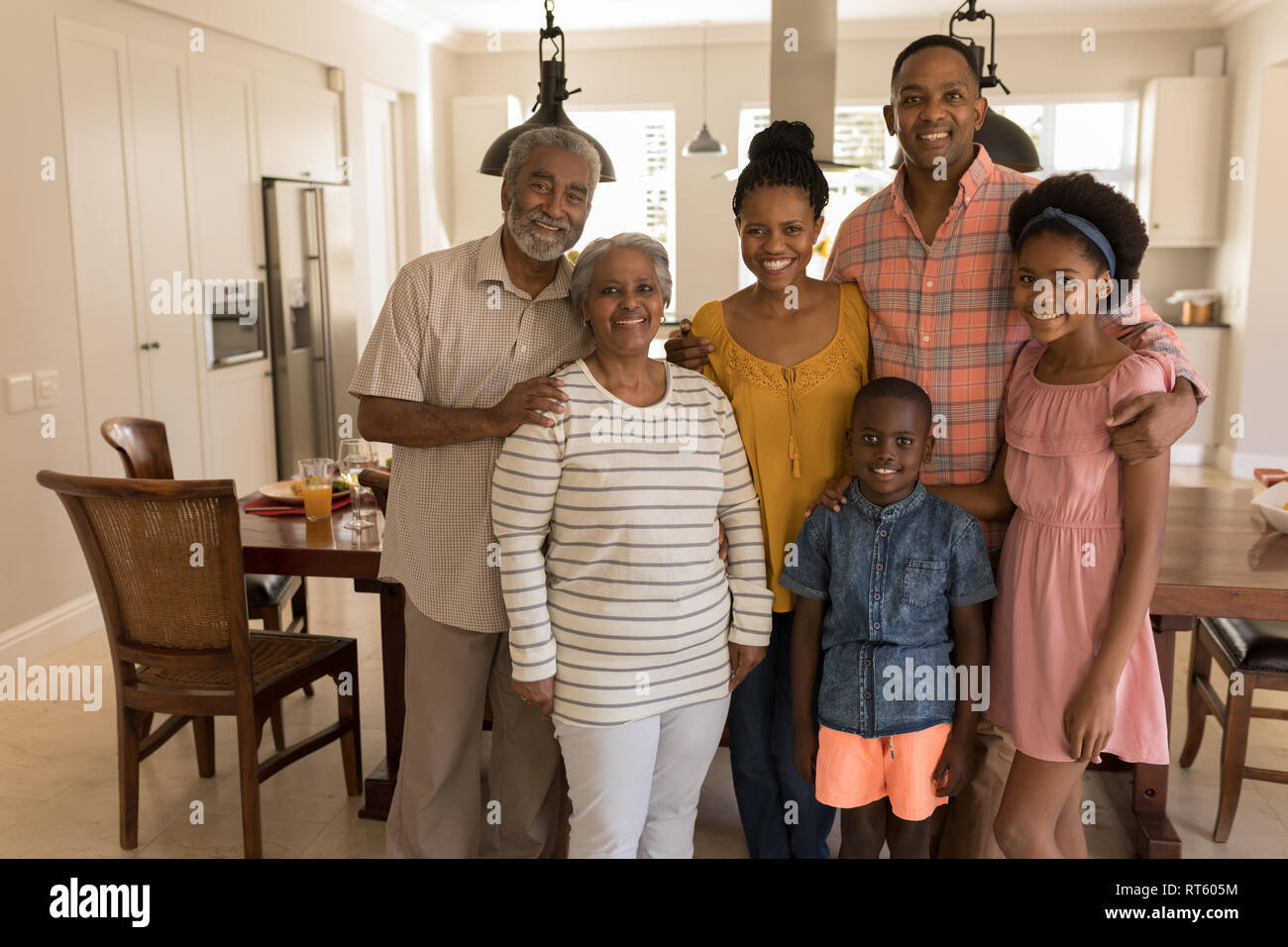 Multi-generation family standing together at home Stock Photo - Alamy