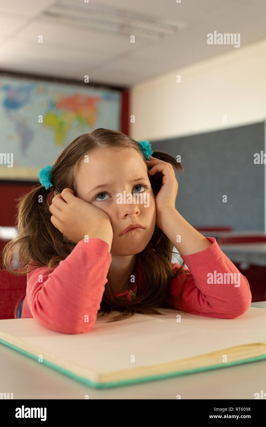 Sad girl sitting in classroom hi-res stock photography and images - Alamy