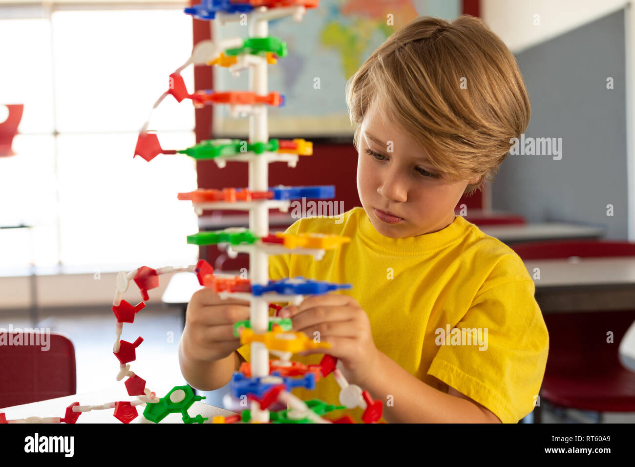 Boy studying science model in classroom Stock Photo - Alamy