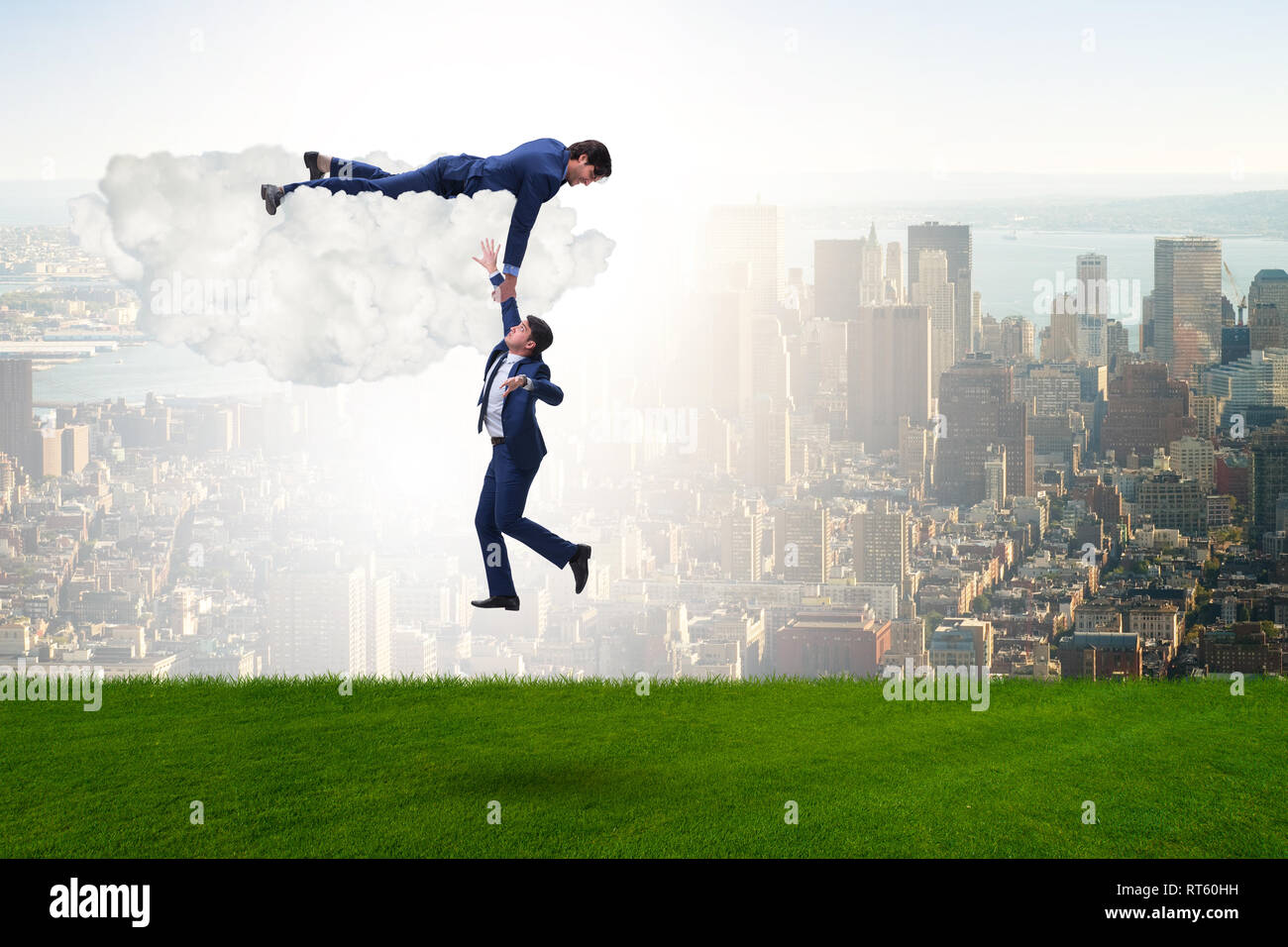 Businessman offering helping hand to falling colleague Stock Photo - Alamy