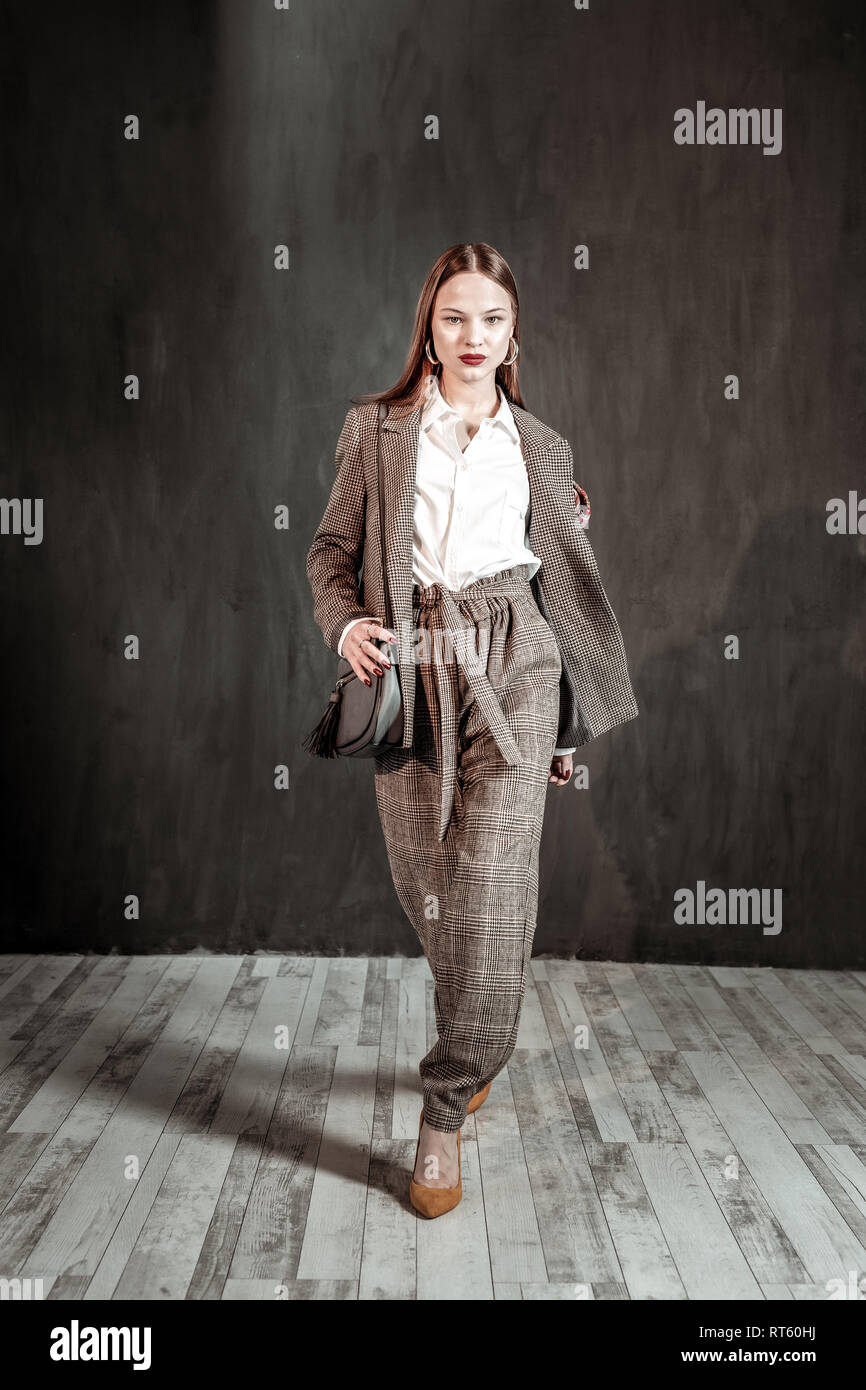 Self confidence. Cheerful young woman going forward while being on ...