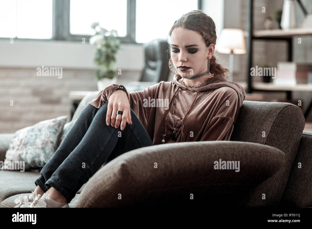 Stressed teenager. Emotional teenager with smoky eyes wearing many ...