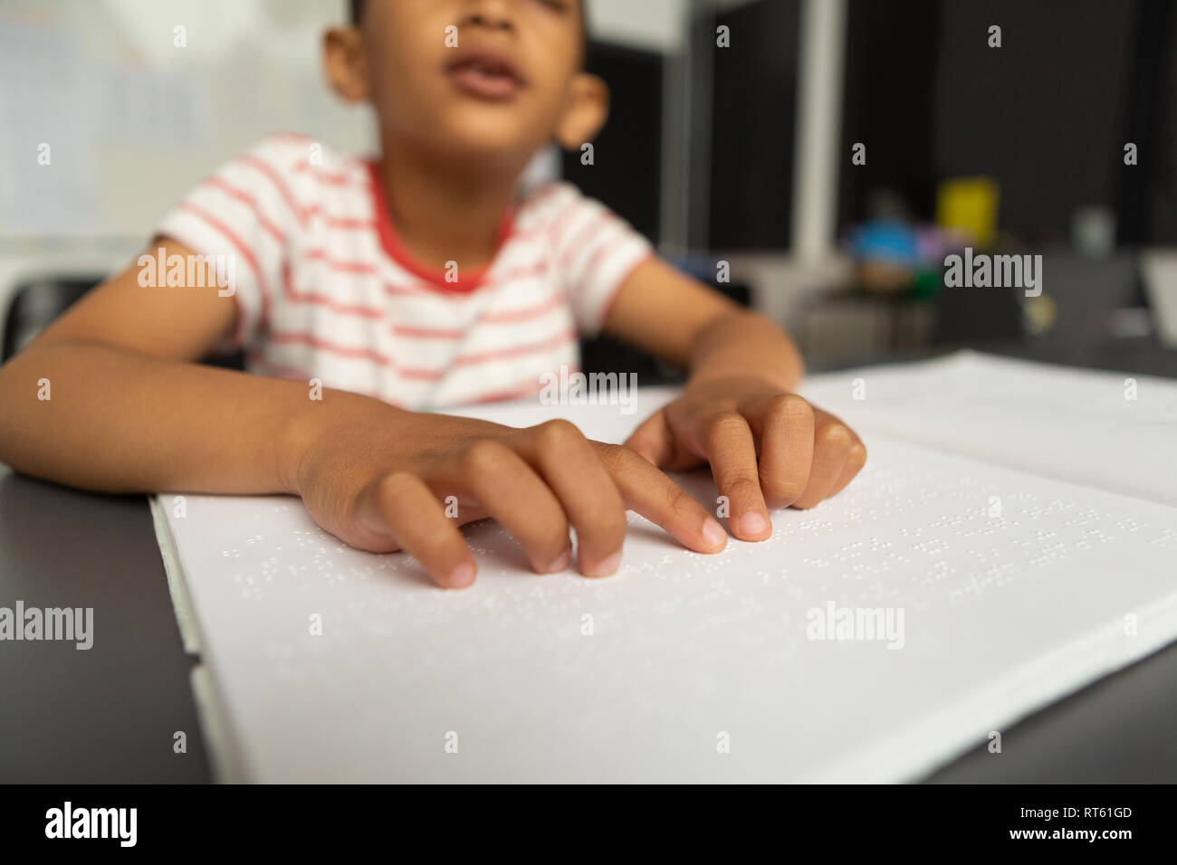 Blind schoolboy hands reading a braille book in classroom Stock Photo ...