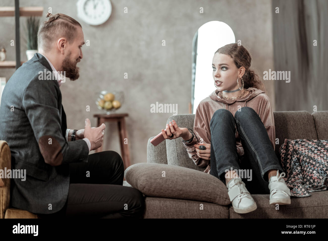 Emotional talk. Stylish teenage girl with dark makeup having emotional ...