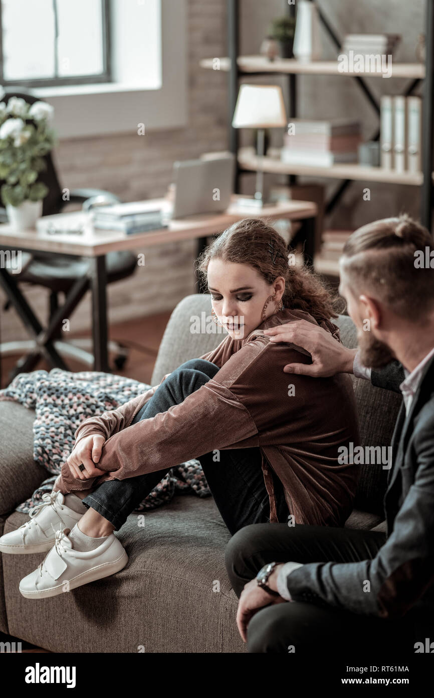 Concerned father. Concerned father touching shoulder of his depressed ...