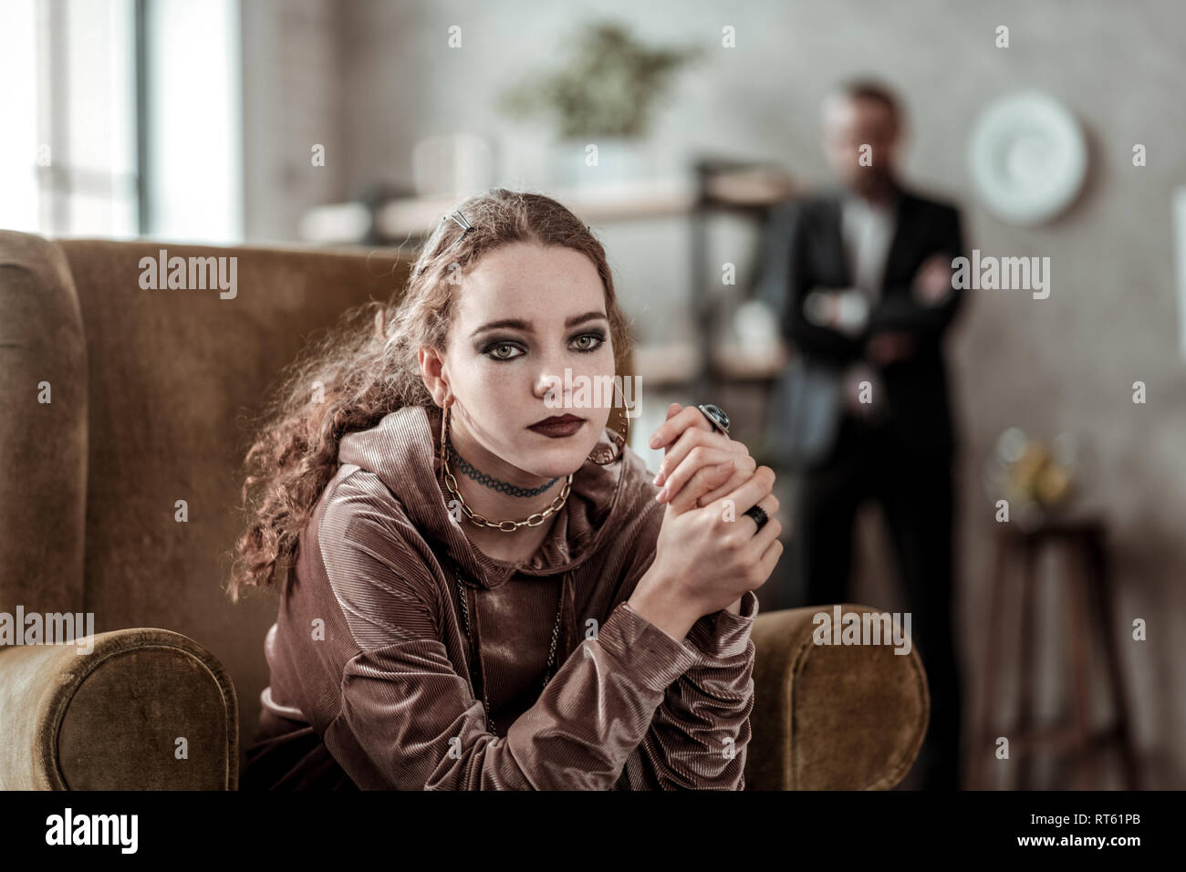 Feeling stressed. Curly teenage girl with dark eye shades and lips ...