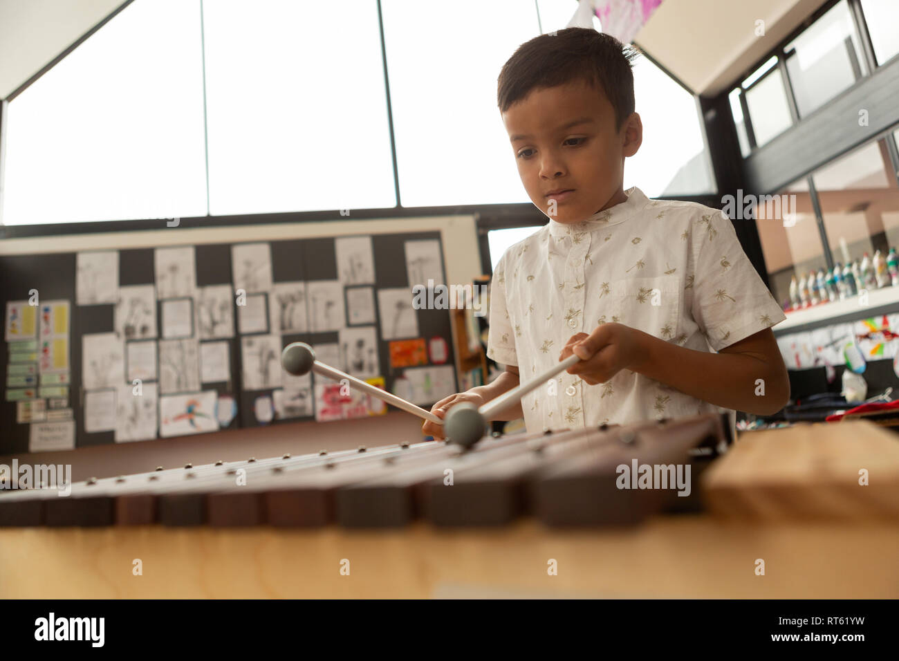 Schoolboy playing xylophone in a classroom Stock Photo - Alamy
