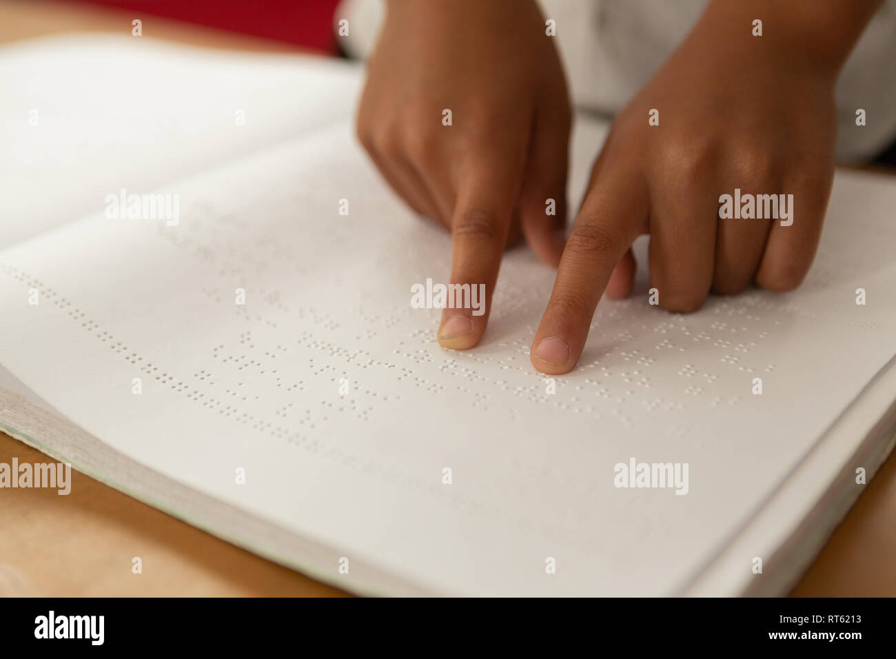 Blind schoolboy hands reading a braille book in classroom Stock Photo ...