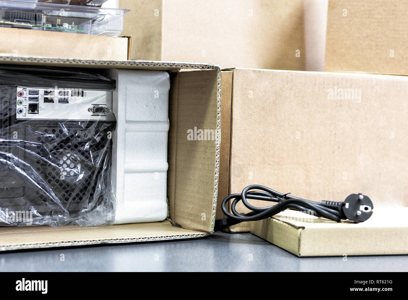 unpacking black personal computer, back view, cellophane packaging ...