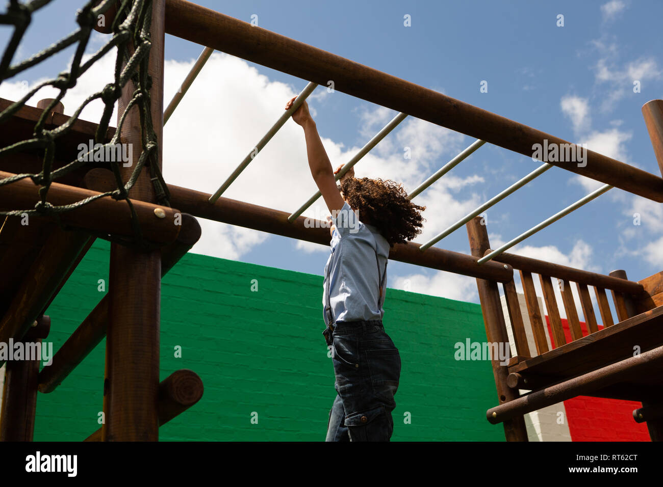 Schoolgirl playing on horizontal ladder in the school playground Stock ...