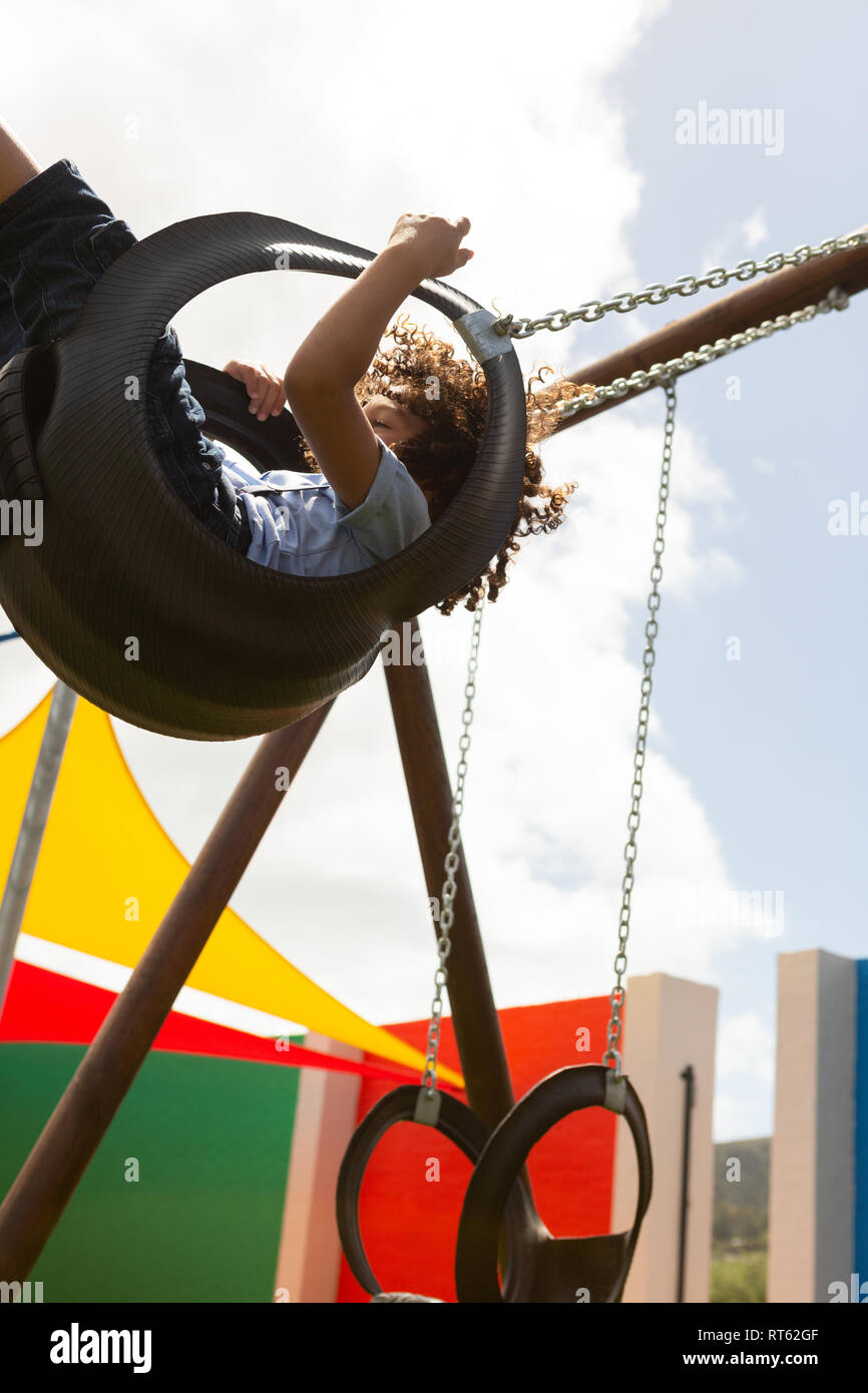 Schoolgirl playing in a swing swing in the school playground Stock ...