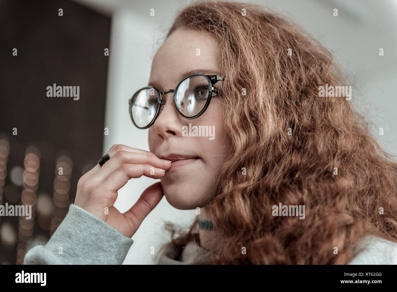 Wearing glasses. Curly dark-haired beautiful teenage girl wearing ...