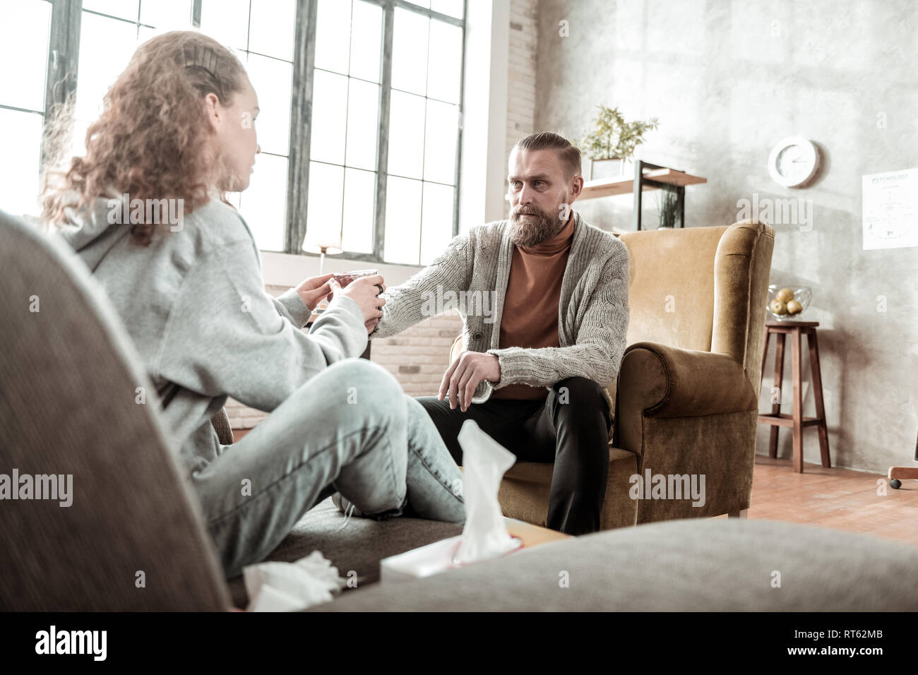 Giving some water. Counselor wearing orange polo neck giving some water ...