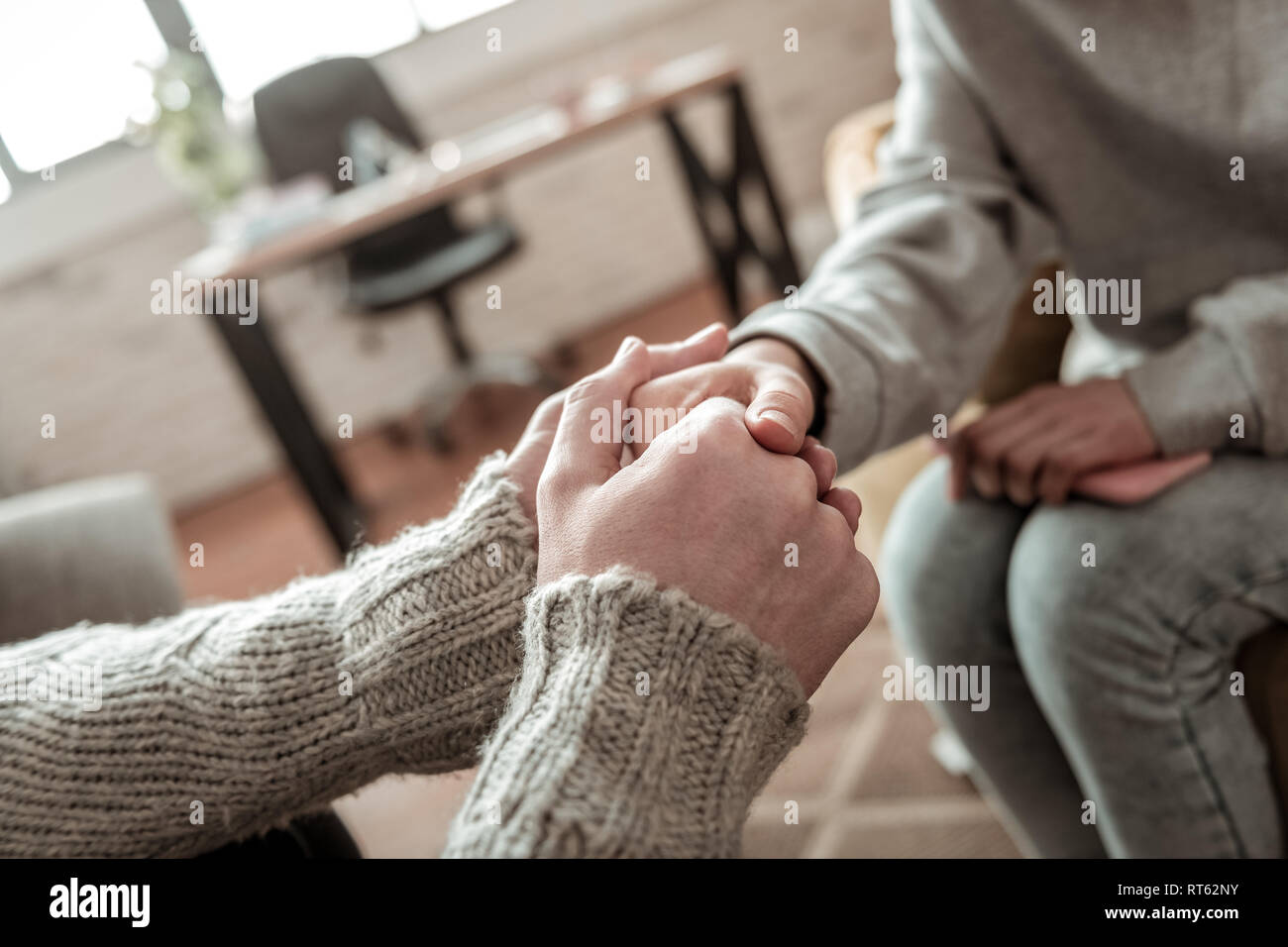 After sincere talk. Father wearing grey sweater shaking hand of his ...