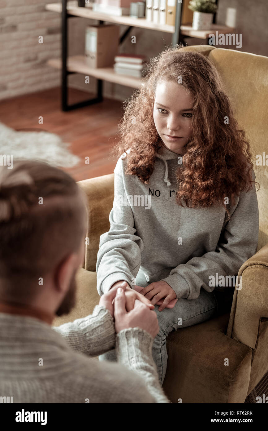 Hand of father. Curly teenager holding hand of her supportive father ...