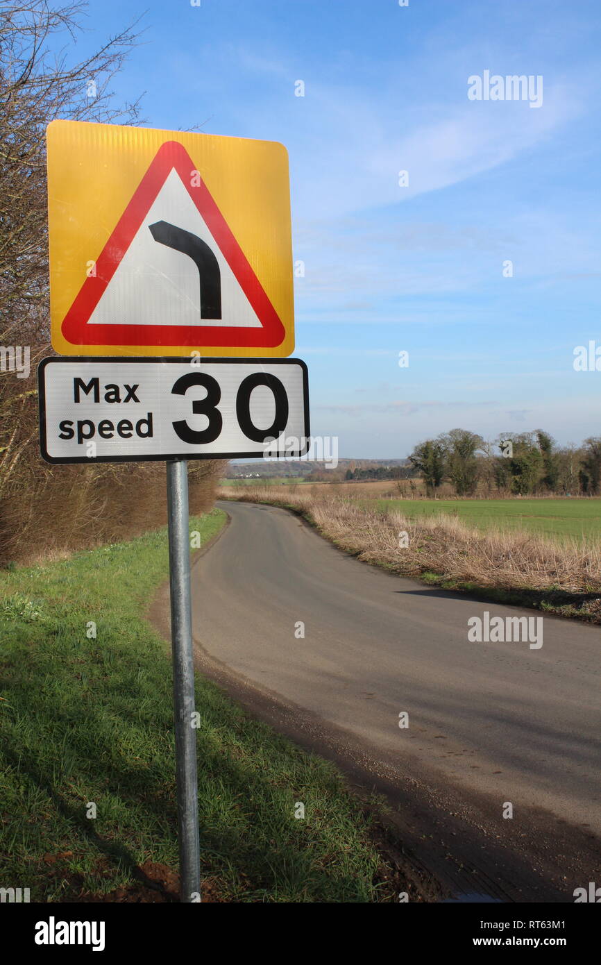 Road sign 30 miles an hour sign Waring of bad bend in country road ...