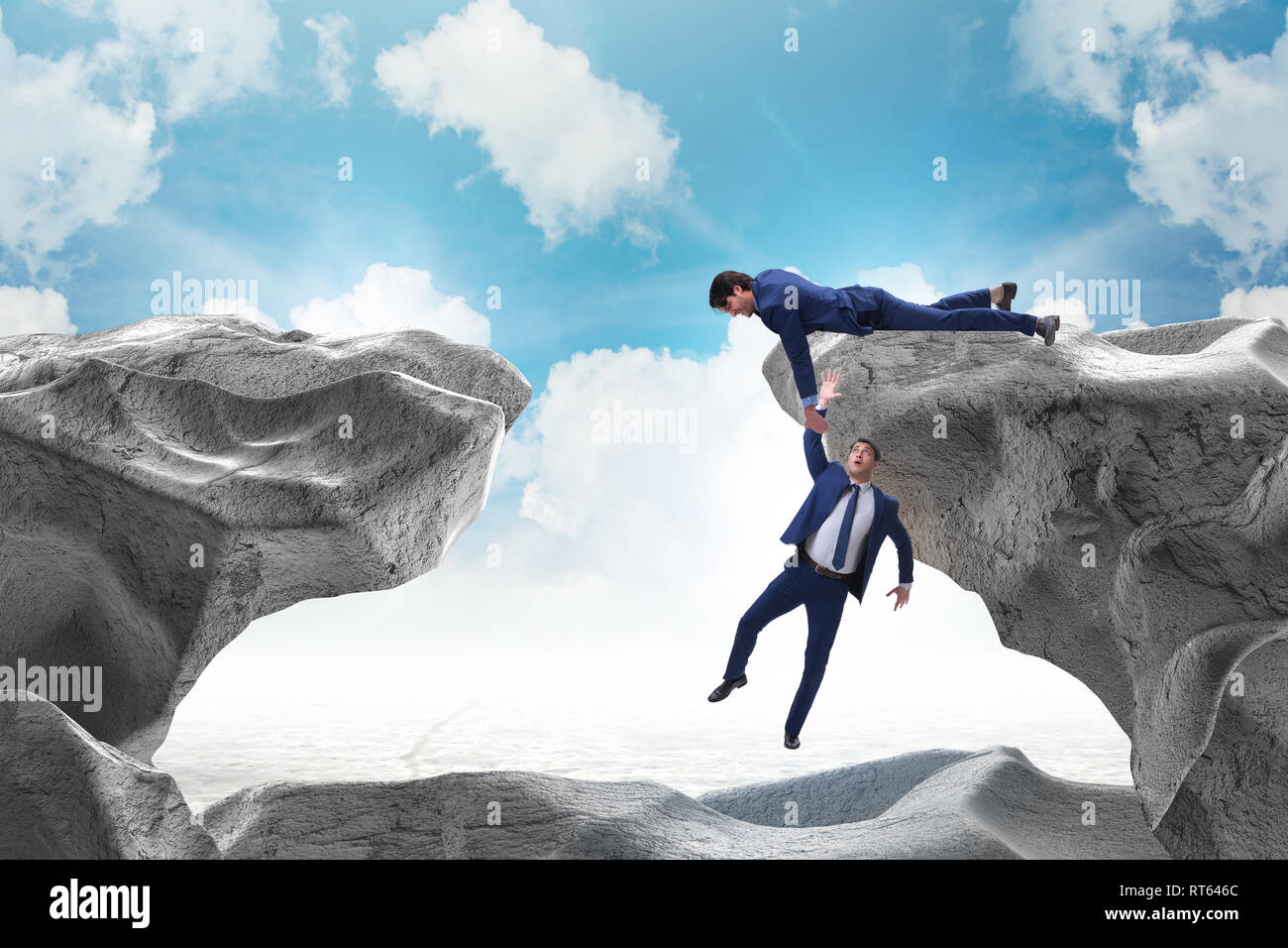 Businessman offering helping hand to falling colleague Stock Photo - Alamy