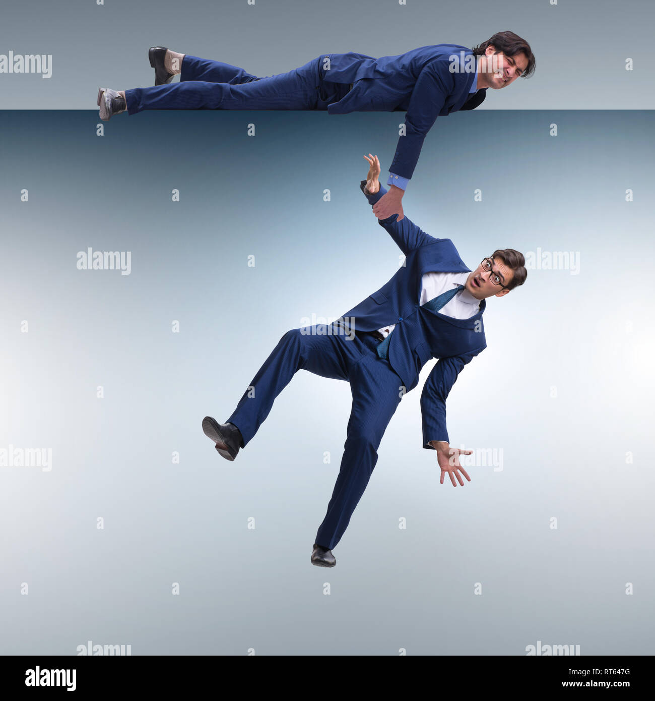 Businessman offering helping hand to falling colleague Stock Photo - Alamy