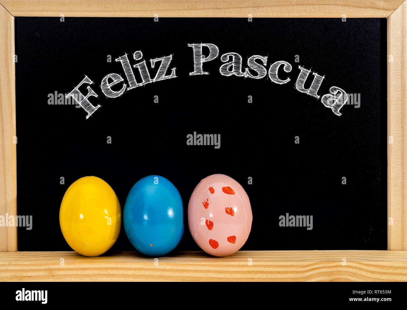 Easter frame with painted eggs and chalkboard. Happy Easter in white ...