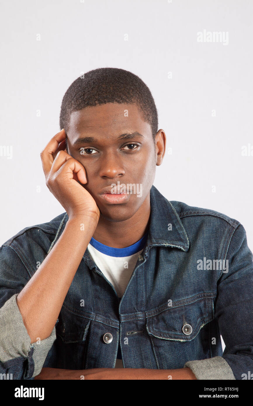 Pensive Black man with his head in his hands Stock Photo - Alamy