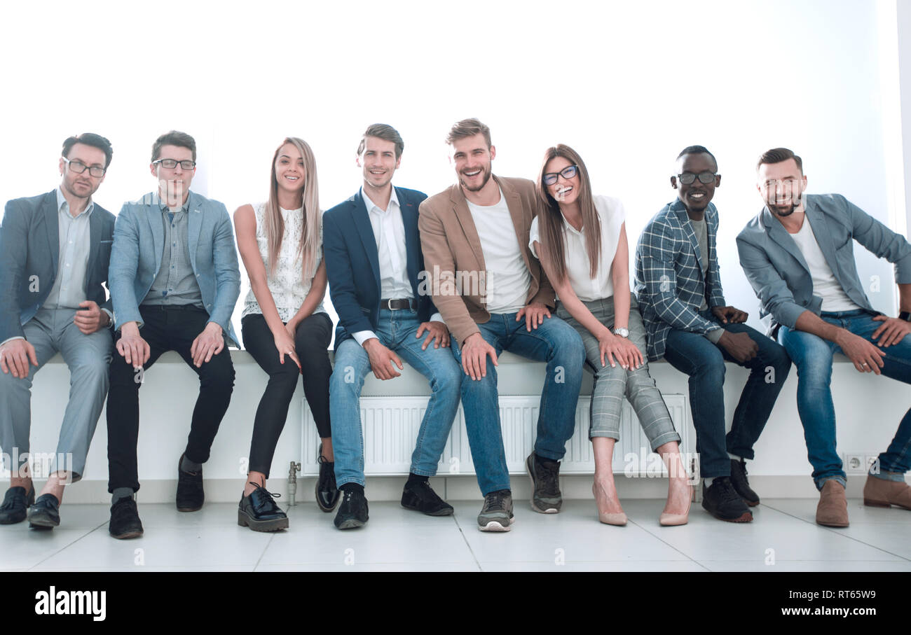 young people are waiting for an interview, sitting in the office lobby ...
