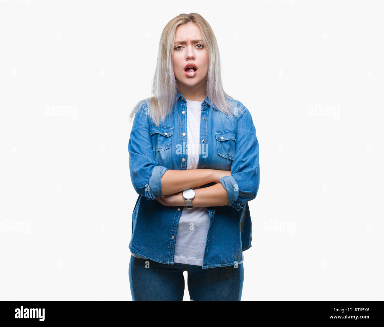 Young blonde woman over isolated background skeptic and nervous ...