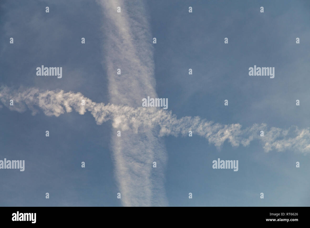 Blue sky with crossing condensation trails hi-res stock photography and ...