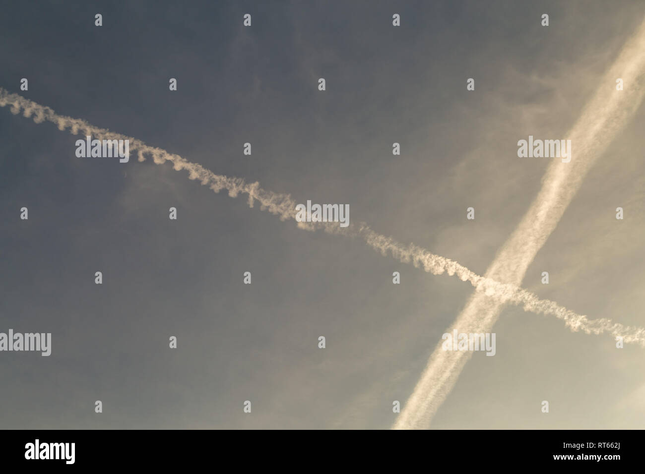 Blue sky with crossing condensation trails hi-res stock photography and ...