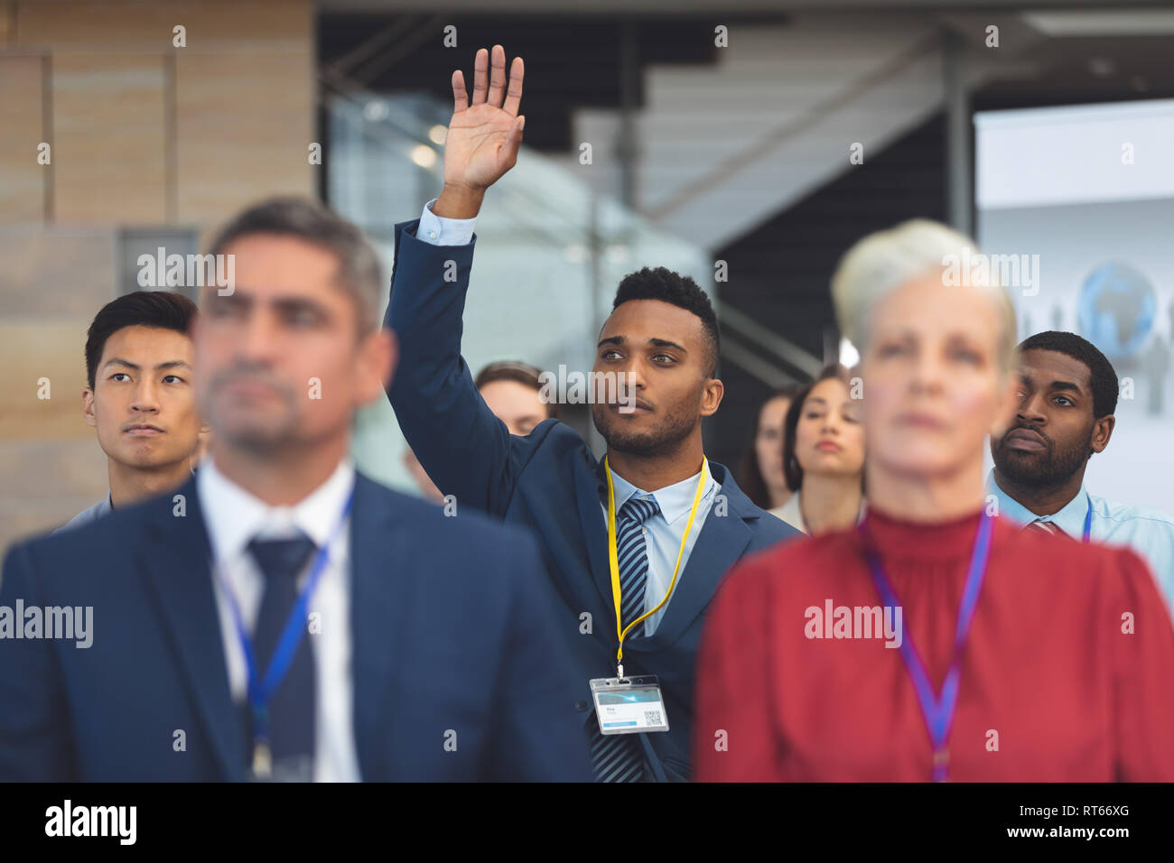 Employee raising hand hi-res stock photography and images - Alamy