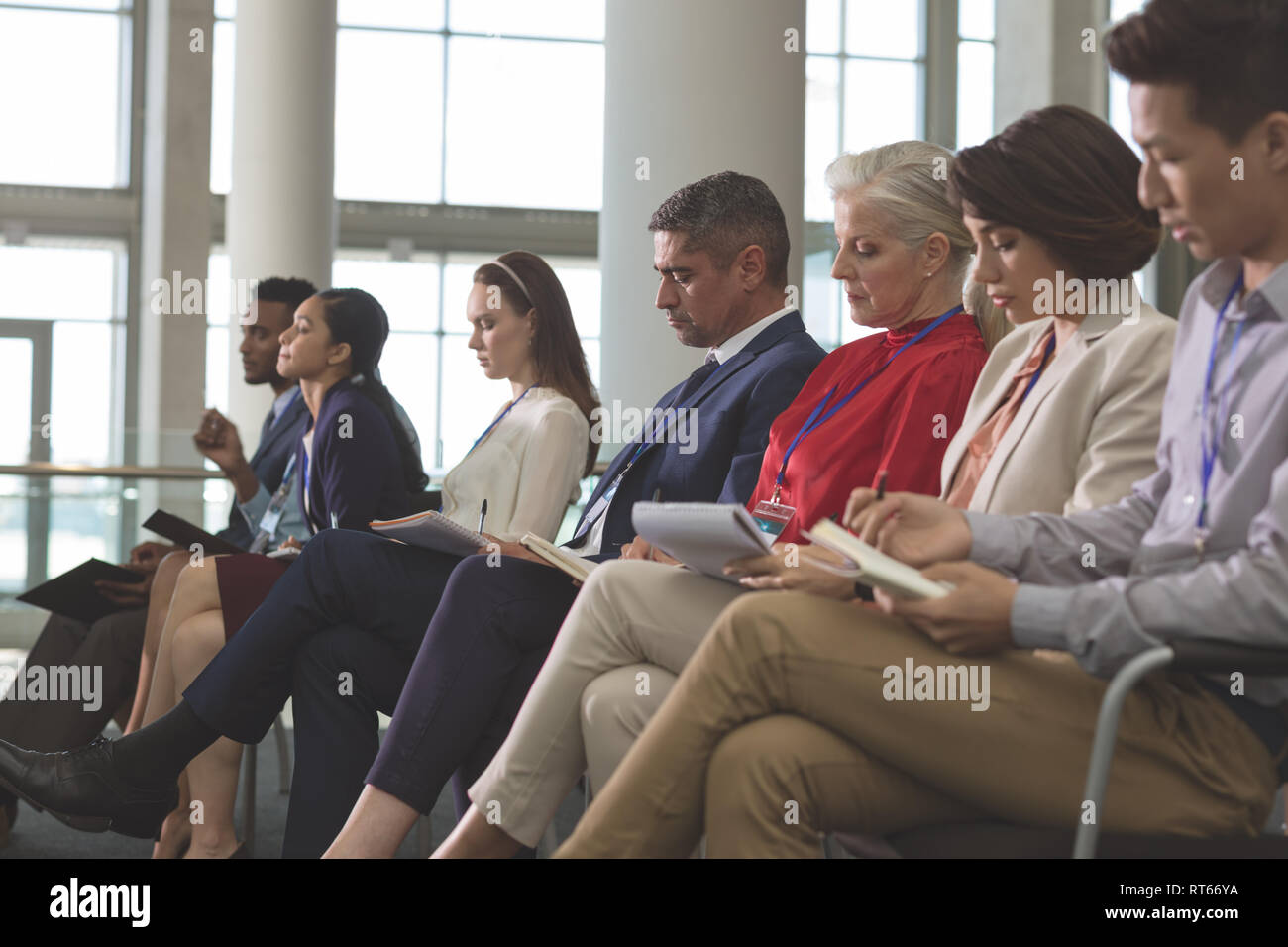 Business people writing on notepad in a business seminar Stock Photo ...