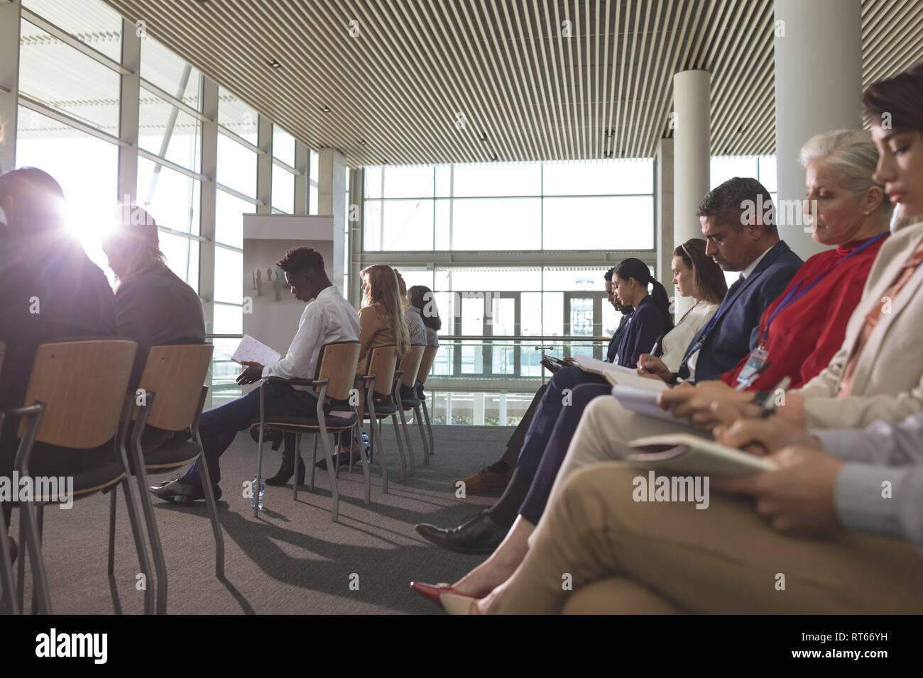 Business people writing on notepad in a business seminar Stock Photo ...