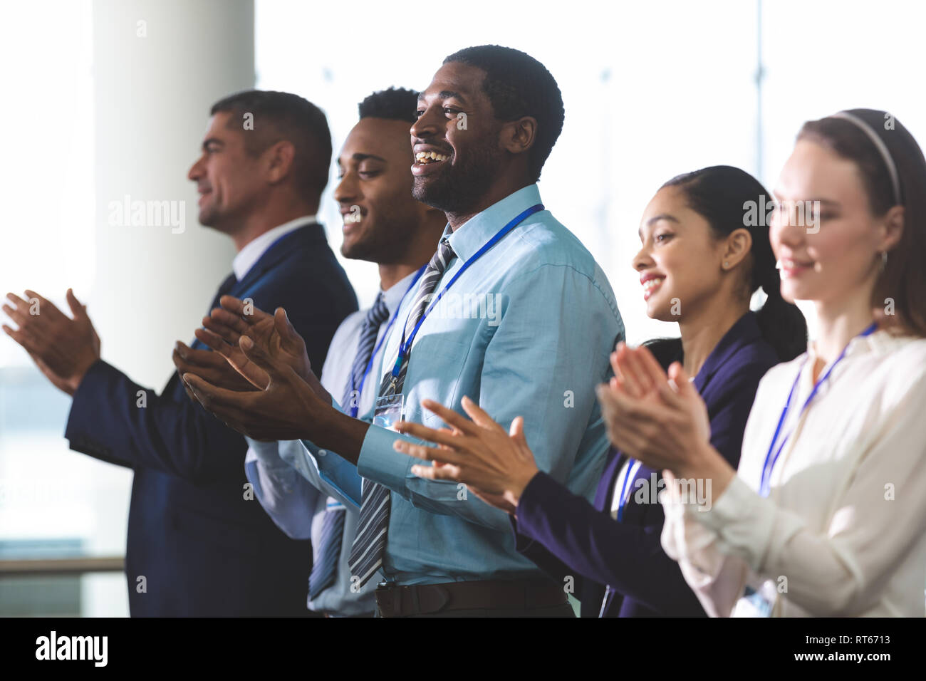Happy colleagues clapping applauding hi-res stock photography and ...