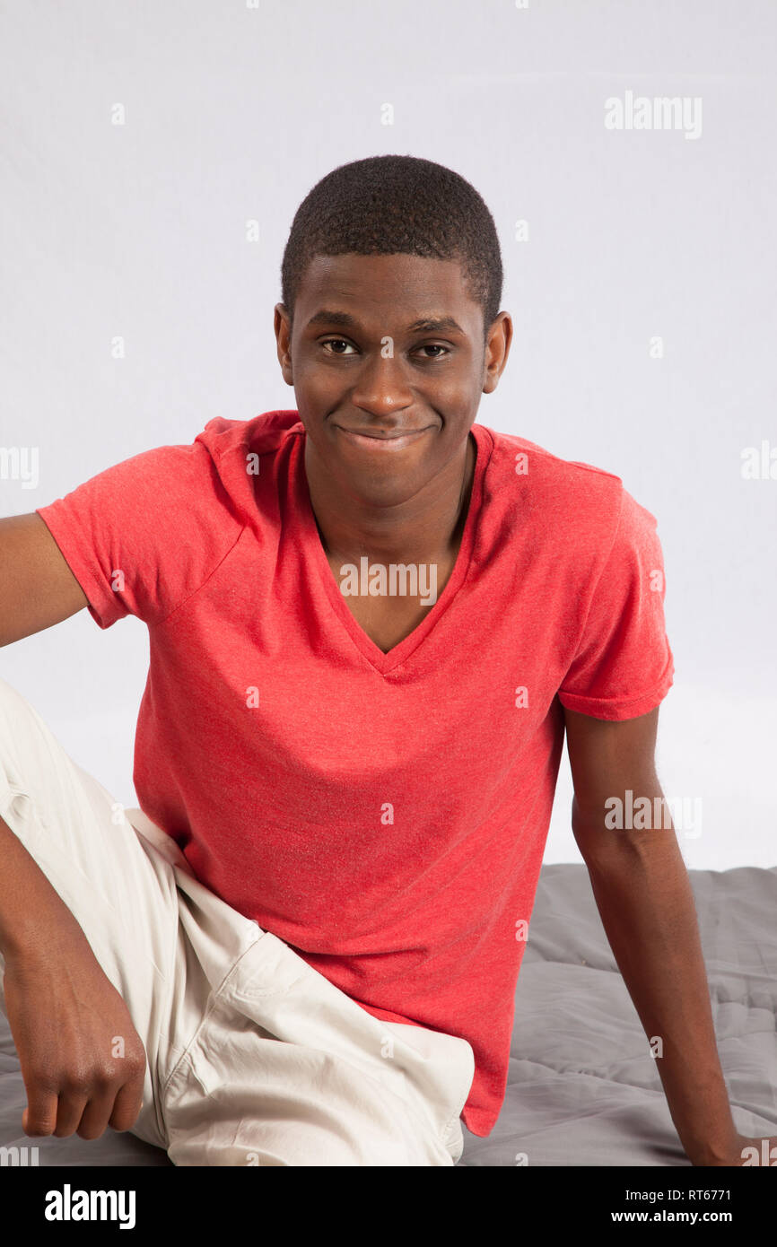 Thoughtful Black man sitting Stock Photo - Alamy