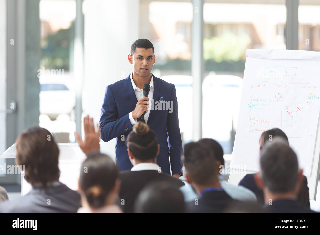 Male speaker speaking with microphone at conference Stock Photo - Alamy