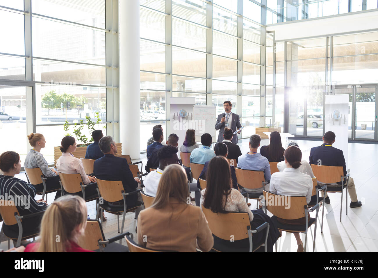Business people listening to businessman and asking questions at ...