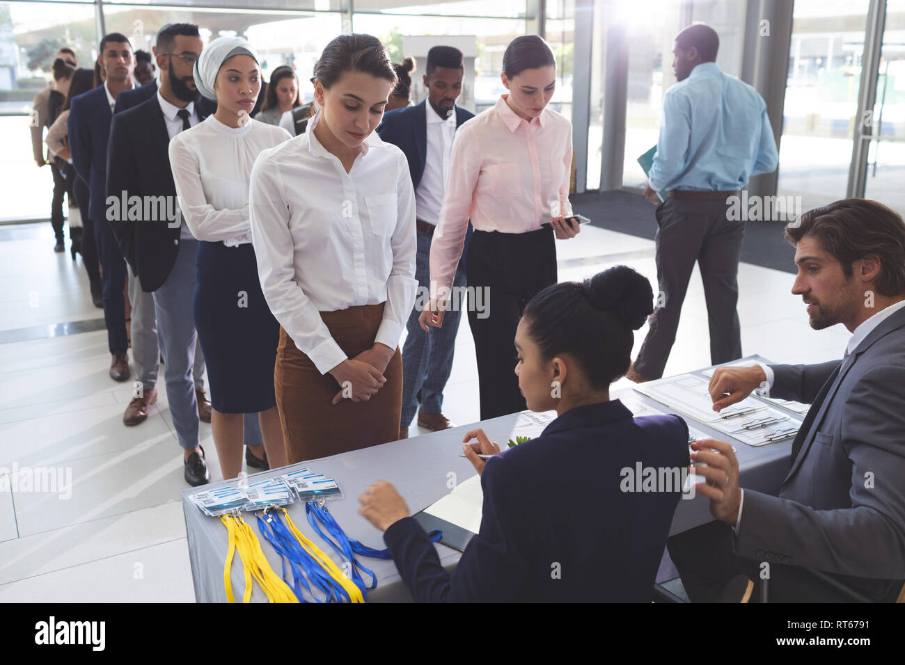 Business people checking in at conference registration table Stock ...