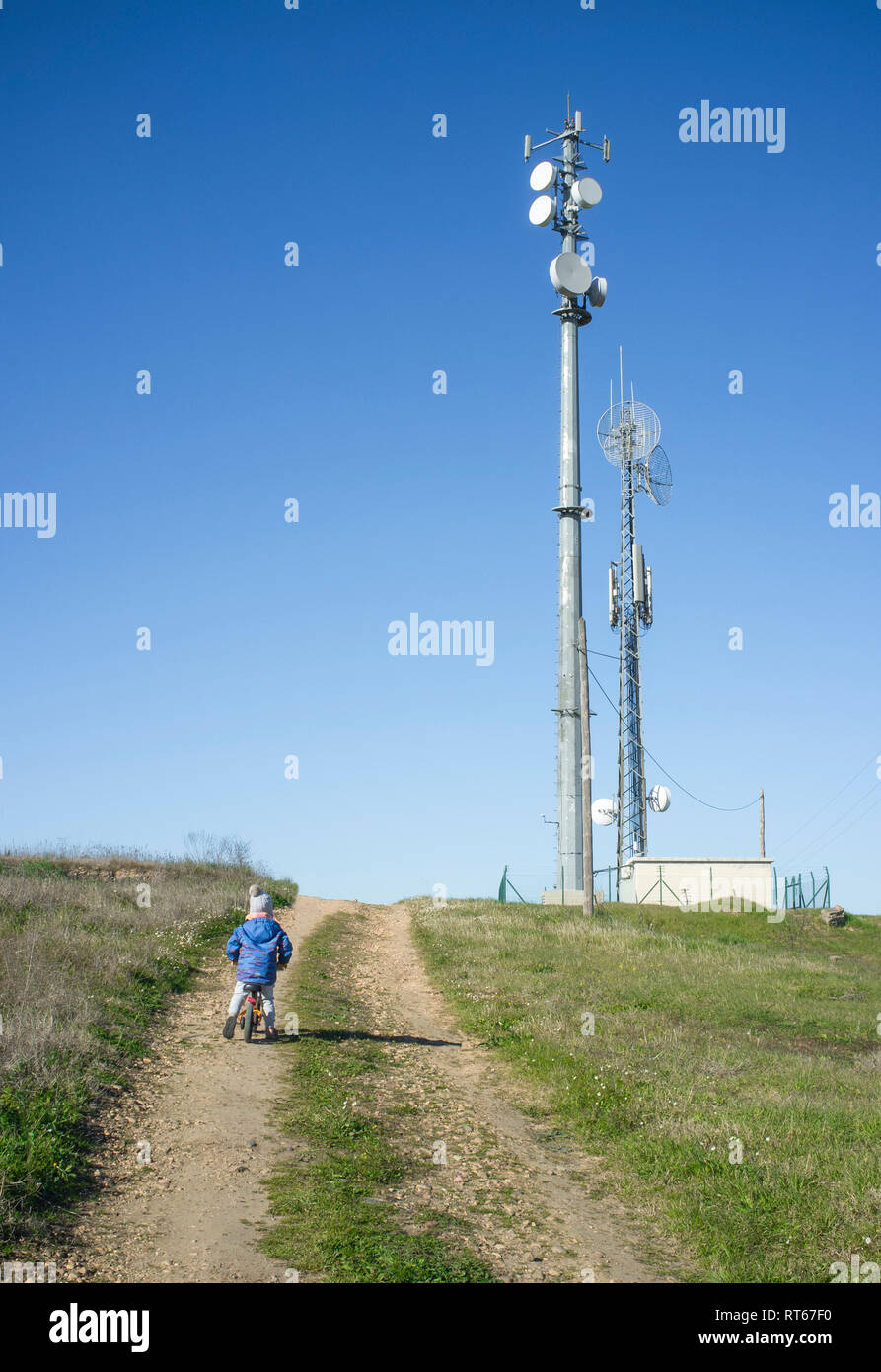 Child boy getting close to mobile antenna. Radiation from mobile phones ...