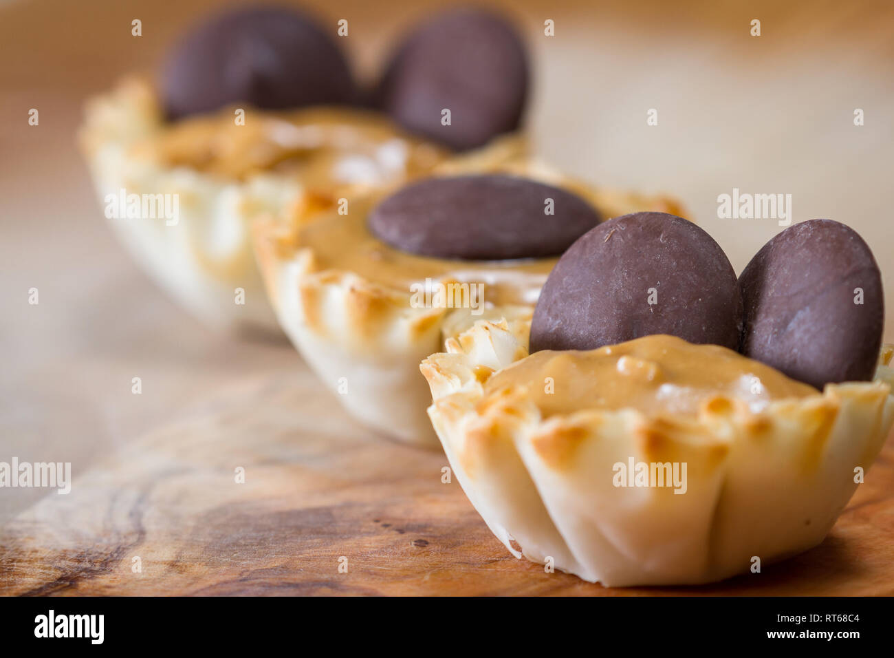 baked phyllo dough cups filled with peanut butter topped with dark ...