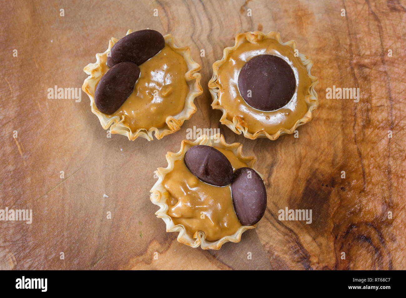 baked phyllo dough cups filled with peanut butter topped with dark ...