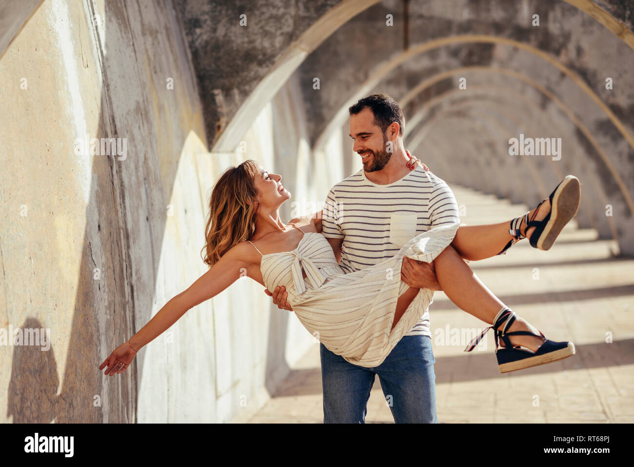 Man carrying girlfriend in arms hi-res stock photography and images - Alamy