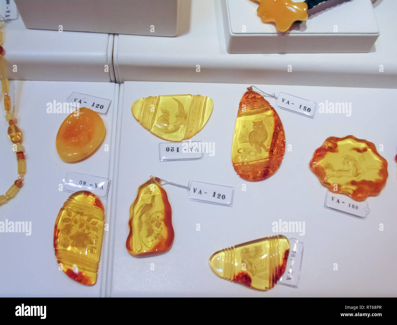 Products and jewelry from amber. Processed amber Stock Photo - Alamy
