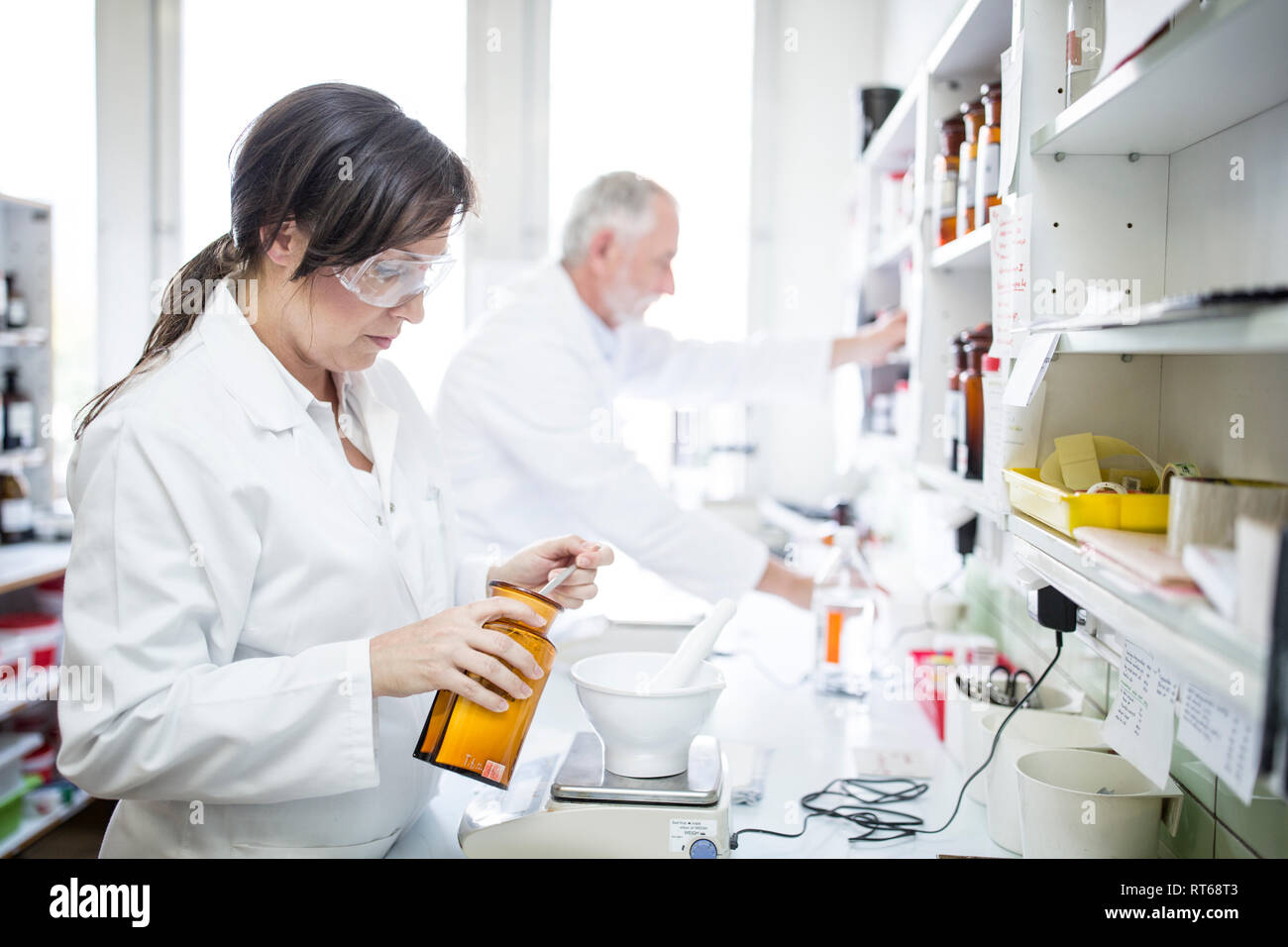 Man and woman working in laboratory of a pharmacy Stock Photo - Alamy