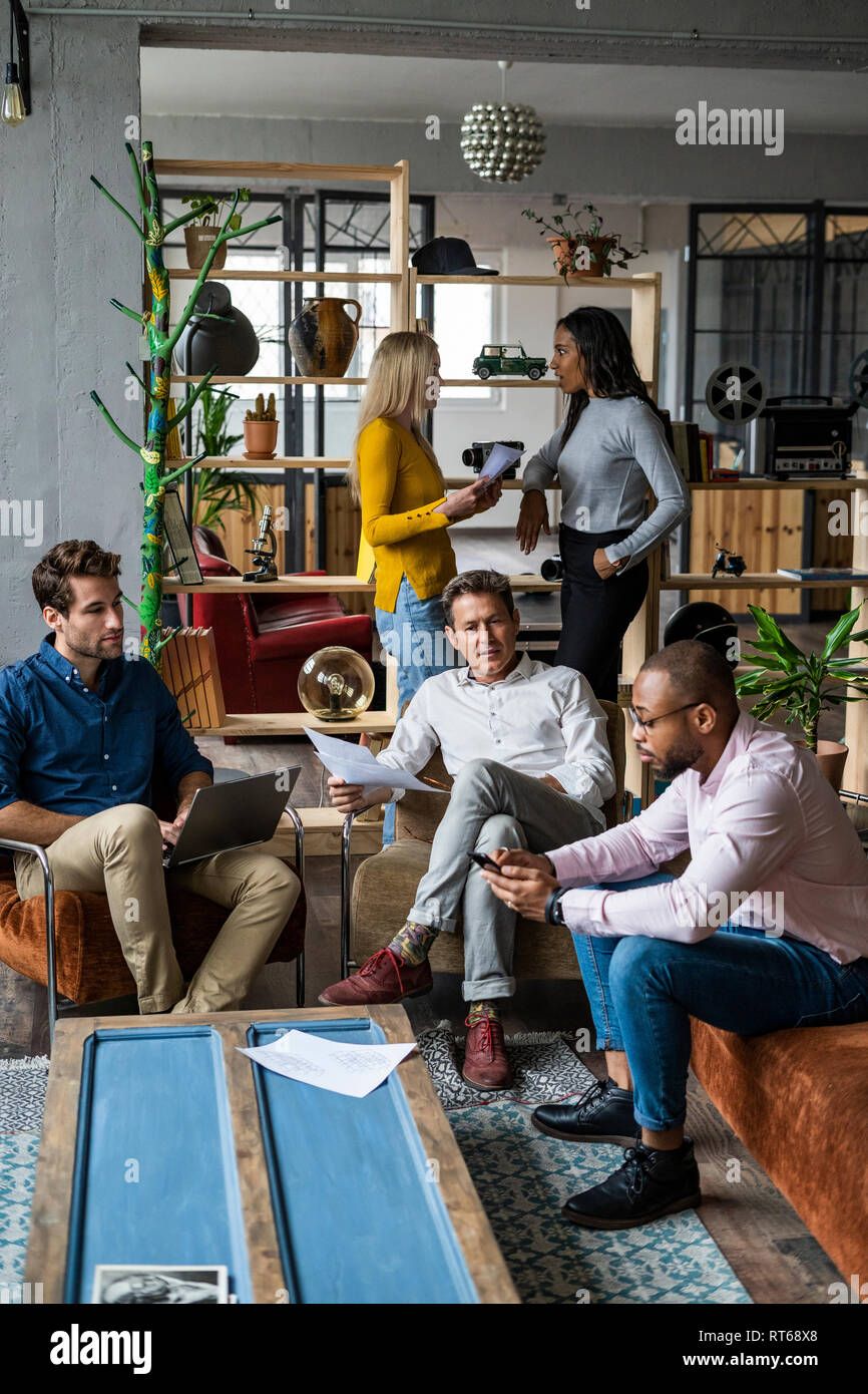 Business team having an informal meeting in loft office Stock Photo - Alamy