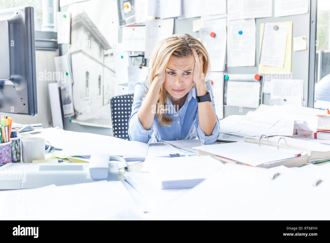 Woman surrounded by paperwork hi-res stock photography and images - Alamy