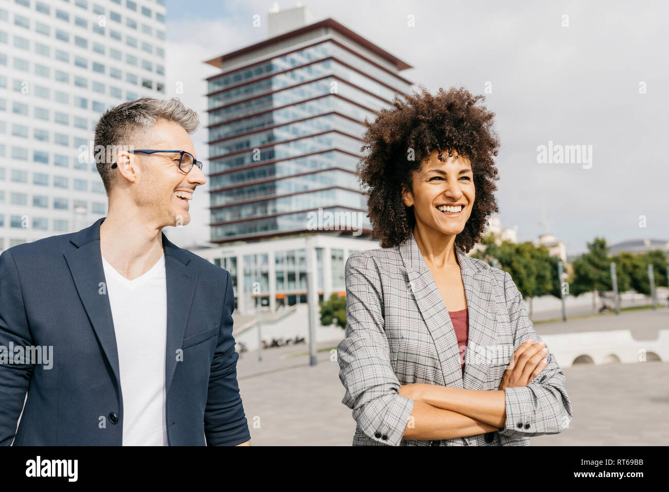 Two happy colleagues talking outside office building Stock Photo - Alamy Two happy colleagues talking outside office building Stock Photo - Alamy
